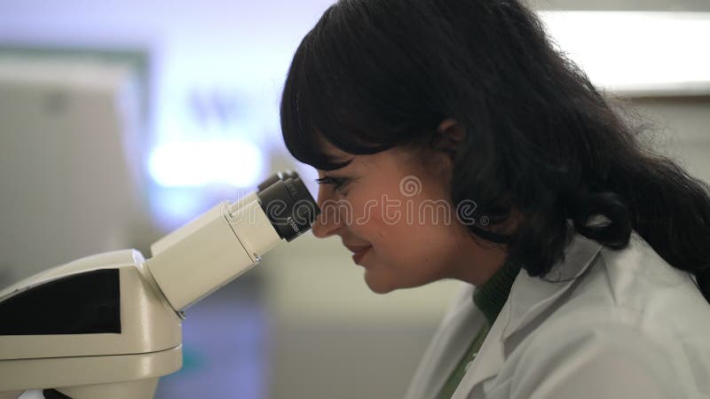 Close-up of a Female Scientist Focused on Observing a Sample Under a ...