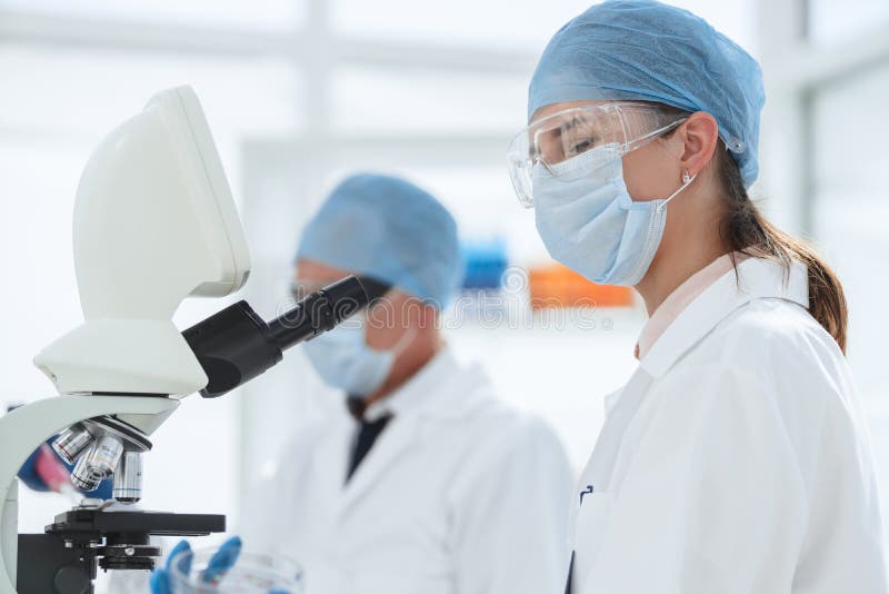 Close Up. Female Scientist Looking through a Microscope Stock Image ...