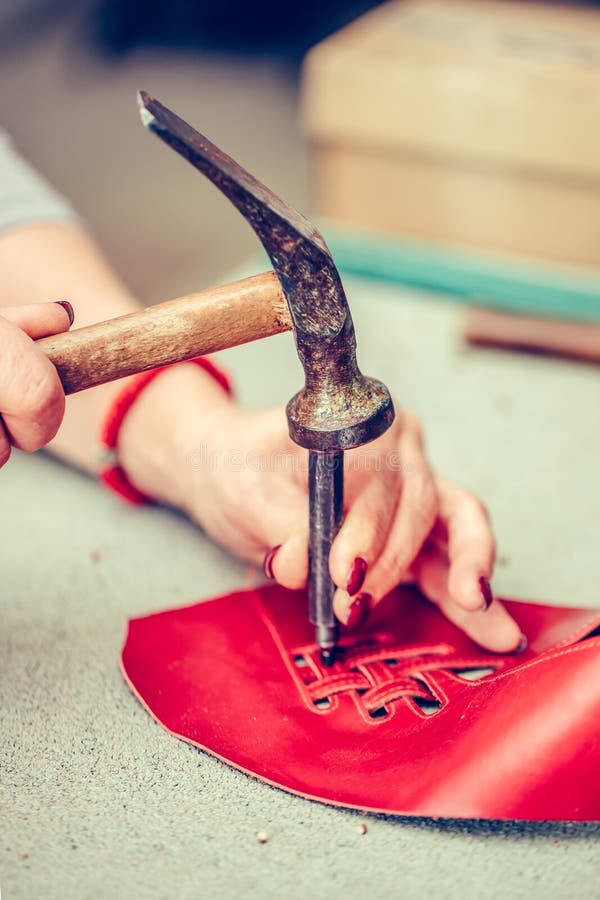 Close Up of a Female Shoemaker Working with Leather Using Hammer and ...