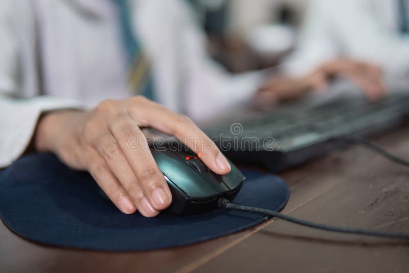 Close Up of a Female Student& X27;s Hand Holding a Mouse while Using a ...