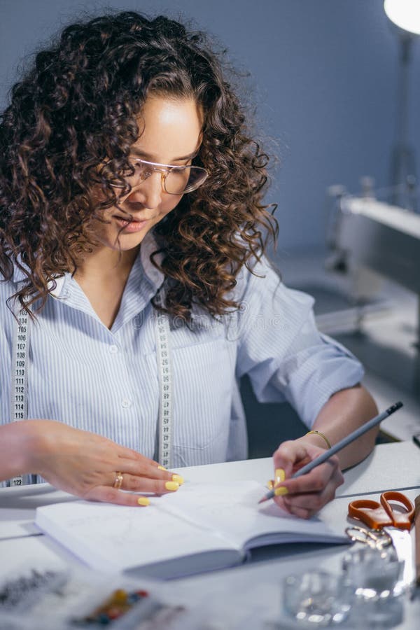 Close Up of Female Tailor Keeping a Personal Diary after Work Indoors ...