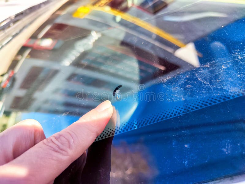 Close-Up of a Finger Pointing at a Chip on a Car Window in Daylight ...