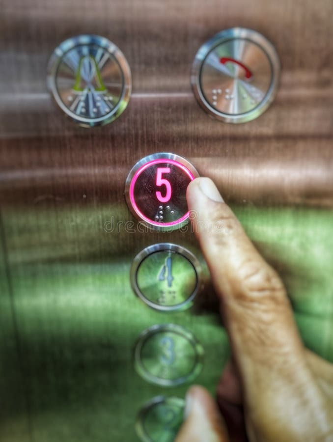 Close-up of Finger Press Elevator Button To the Fifth Floor of the ...