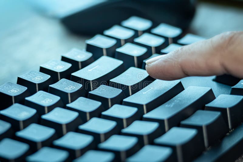 Close-up of a Finger Pressing the Enter Key on a Black Computer ...