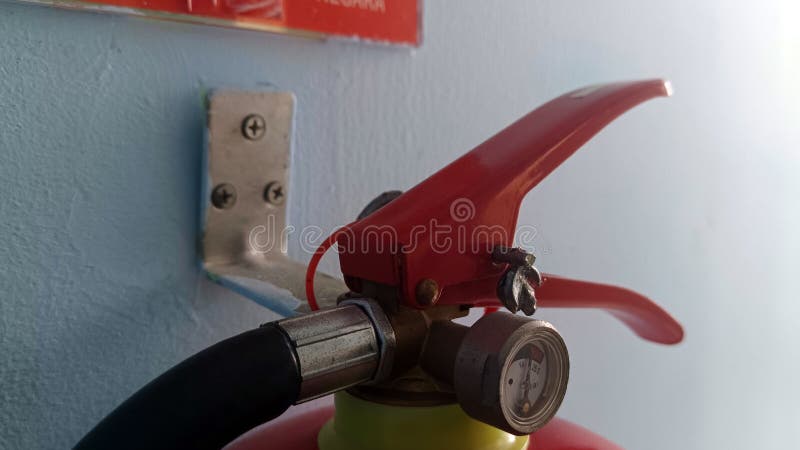 Fire Extinguisher on Blue Wall Stock Image - Image of extinguisher ...