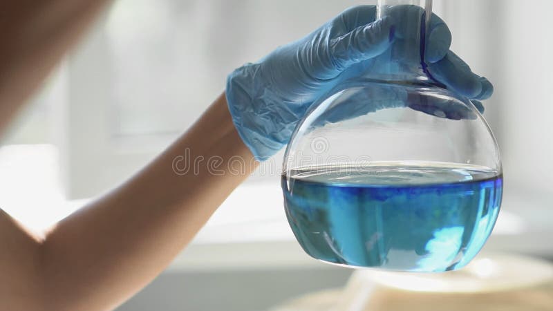 Close-up of a Flask in a Laboratory Experiment, with Blue Liquid ...