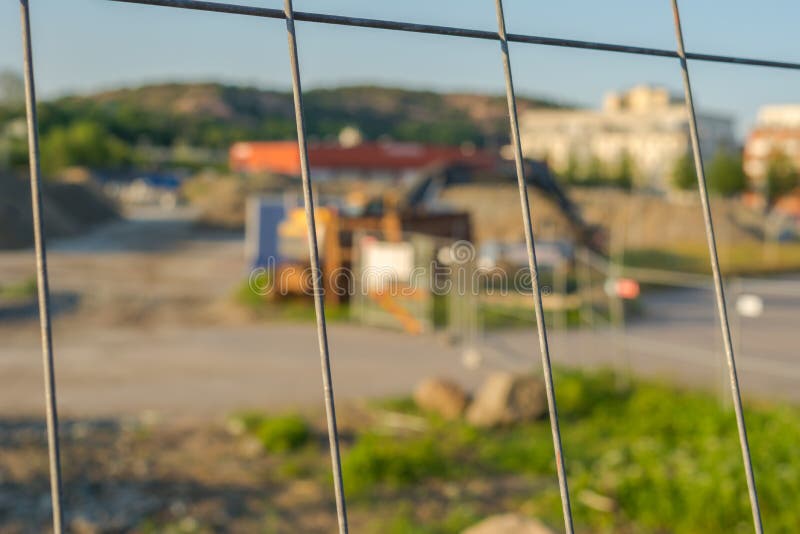 Close-up Focus on Fences with a Construction Site in the Background ...