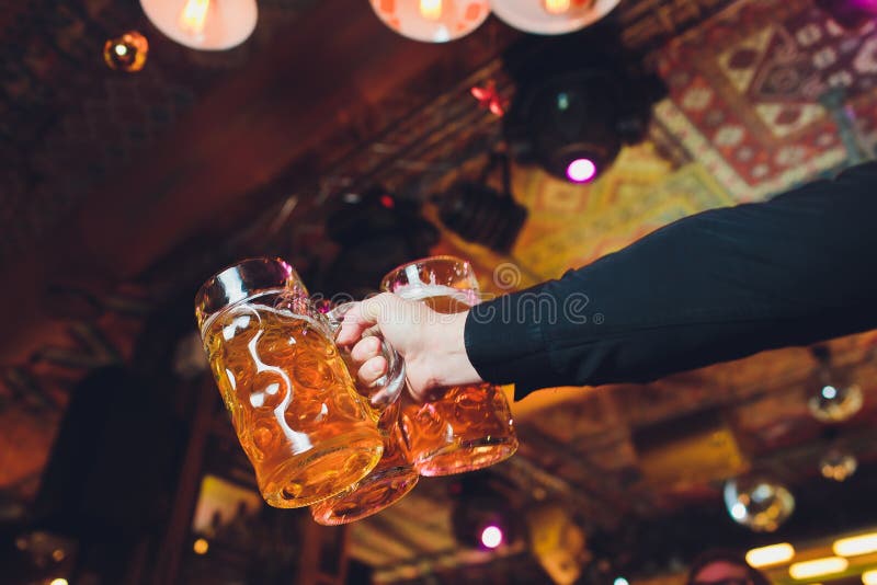 Close Up Focus View of Man`s Hand Holding a Big Glass of Draft Beer in ...