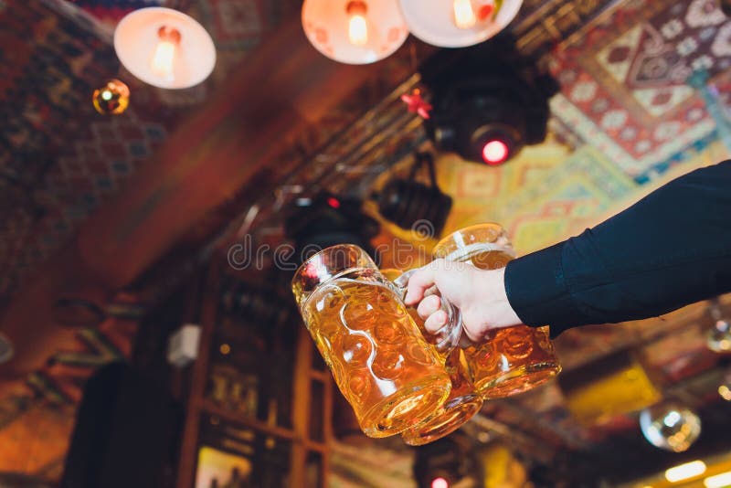 Close Up Focus View of Man`s Hand Holding a Big Glass of Draft Beer in ...