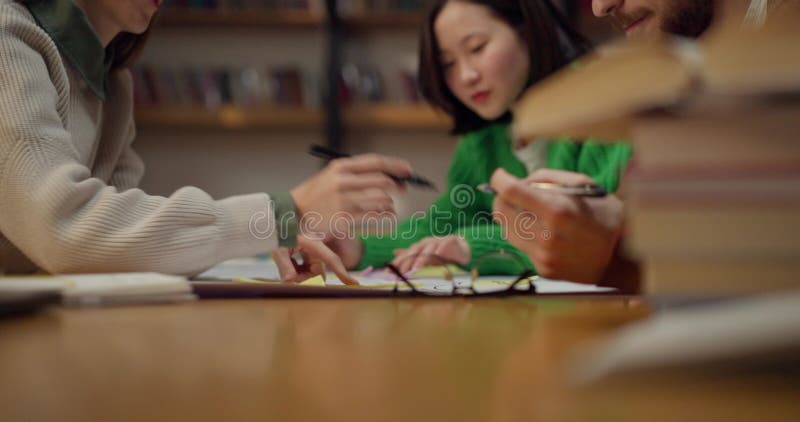 Close Up Focused Students Discussing Their Ideas Taking Notes Using ...