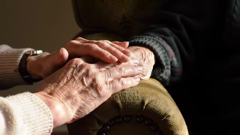 Close Up of Elderly Hands Intertwined in Sunlit Room Expressing Warmth ...