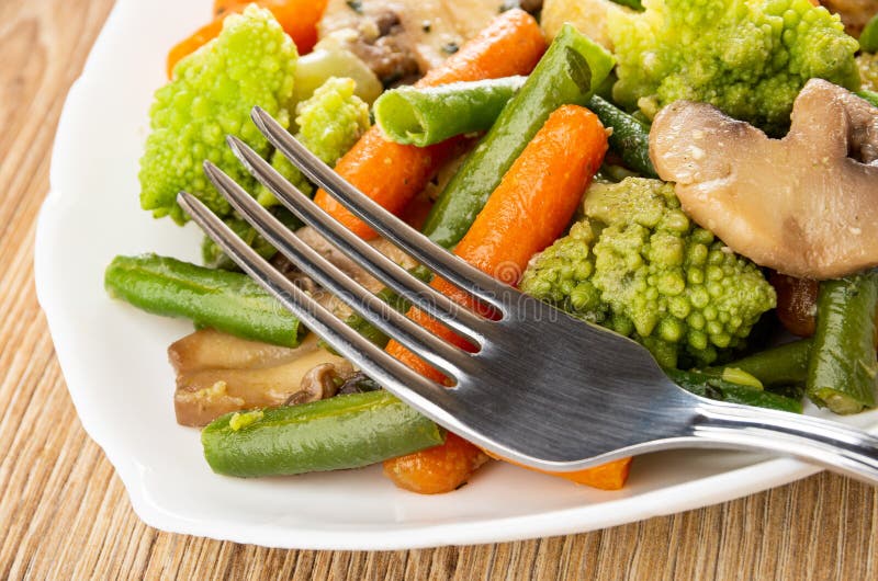 Close Up of Fork in Dish with Fried Vegetable Mix on Table Stock Photo ...