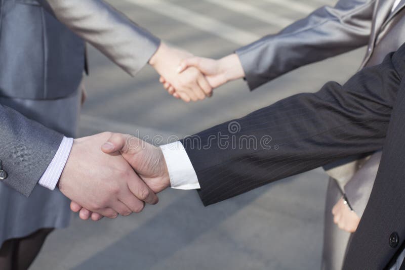 Close Up of Four Business People Shaking Hands Stock Image - Image of ...
