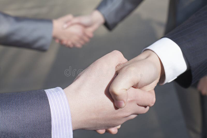 Close Up of Four Business People Shaking Hands Stock Photo - Image of ...