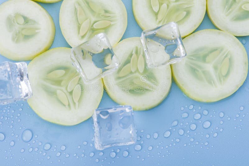 Close Up Fresh Slice Cucumber with Ice Cube on Blue Stock Image - Image ...