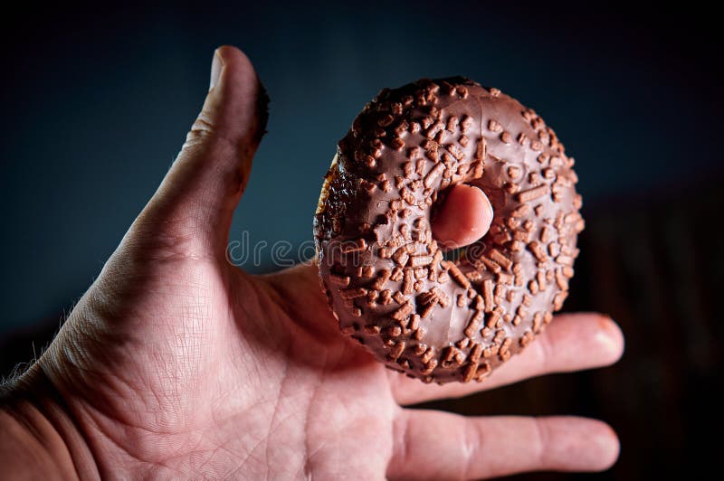 Close-up of Fresh Sweet Donuts on Human Finger Stock Photo - Image of ...