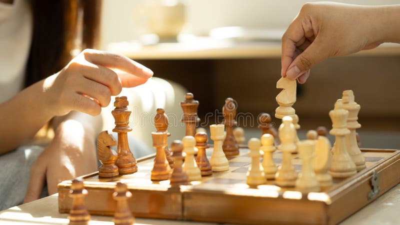 Close Up of Friends Playing Chess Under Warm Natural Light Stock Photo ...