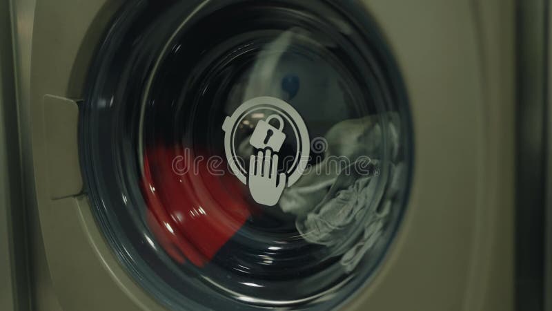 Close-Up of Washing Machine with Clothes Inside in a Laundry Room Stock ...