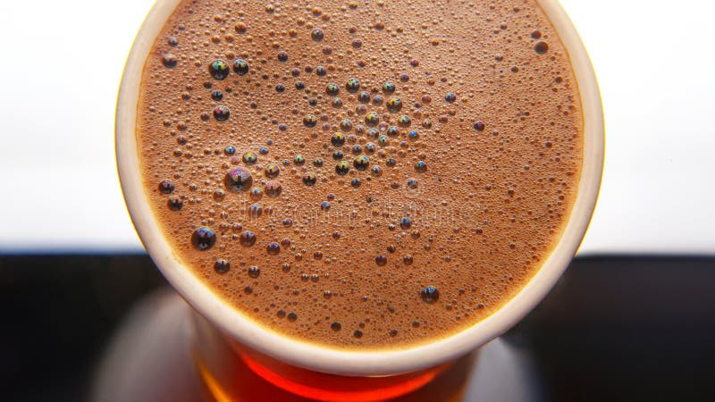 Close-up of a Frothy Coffee Surface with Vibrant, Iridescent Bubbles in ...