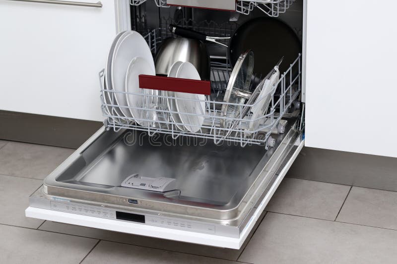 Close Up of a Full Dishwasher with Clean Plates, Lids, Glassware in the ...
