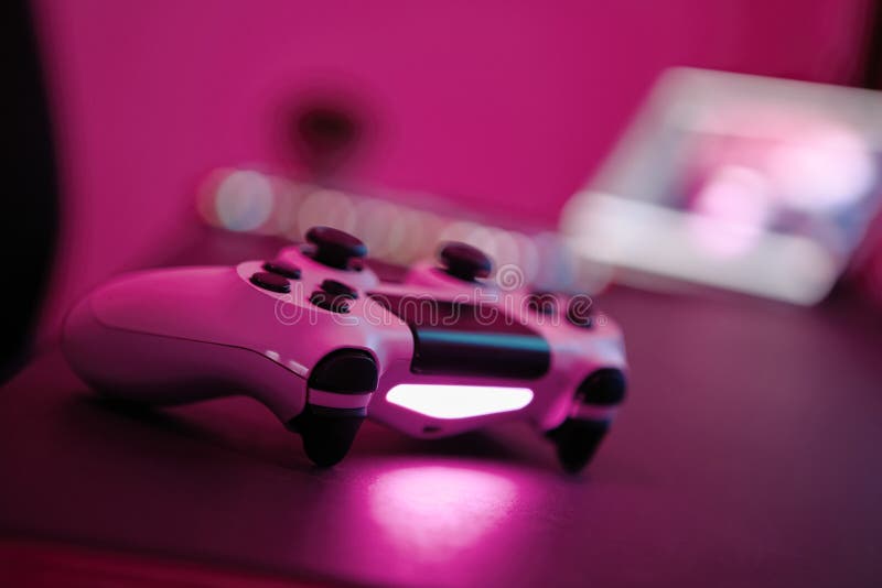 Close-up of Gaming Controller Laying on Table in Purple Illuminated ...