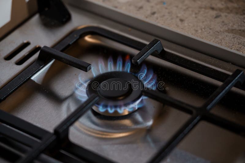 Close-Up of a Gas Stove Burner with Blue Flame Ignition Stock Photo ...
