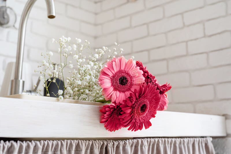 Close Up of Gerbera Daisies in a Kitchen Sink. Rustic Kitchen Interior ...