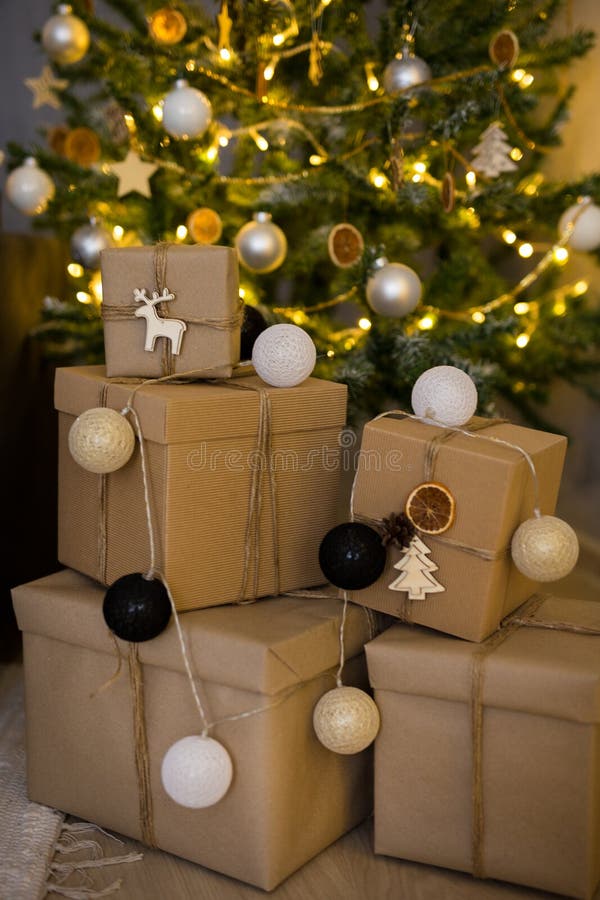 Decorated Christmas Tree, Heap of Gift Boxes Over White Brick Wall with ...