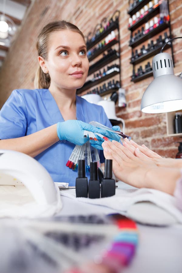 Close-up of Girl Manicurist Showing Schemes of Nail Polish Stock Image ... Close-up of Girl Manicurist Showing Schemes of Nail Polish Stock Image ...
