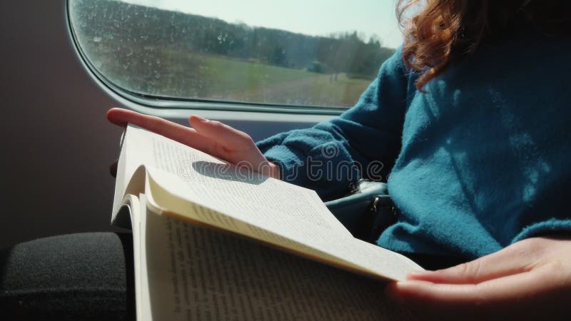 Close Up of Girl Reading Book on Train Stock Footage - Video of station ...
