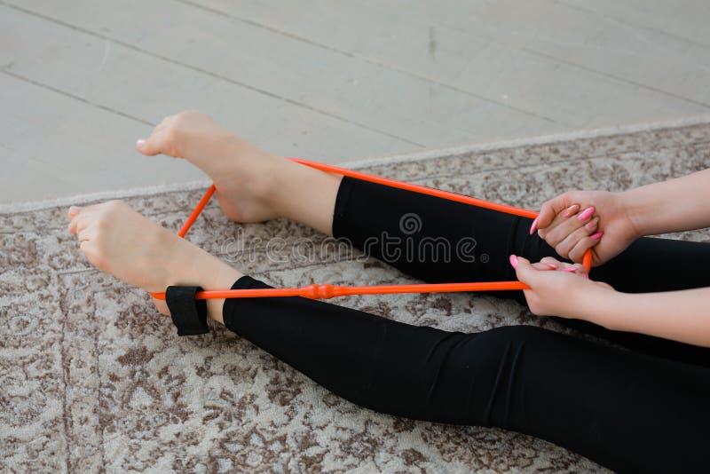 Close-up. Girl Sitting on the Home Mat and Pull of the Foot Stock Image ...