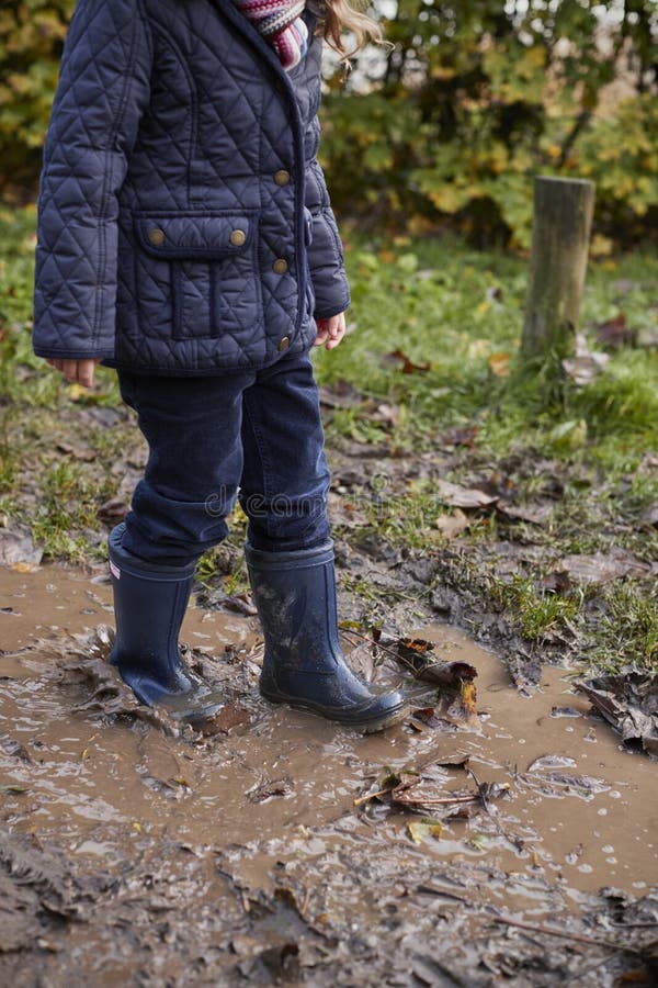 Close Up of Girl Splashing in Puddle on Winter Walk Stock Photo - Image ...