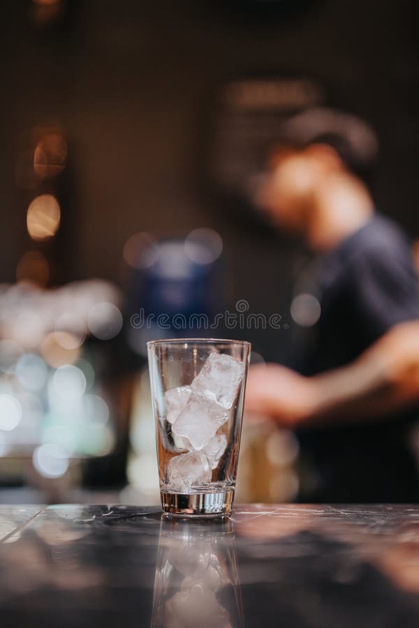 Close-up of a Glass of Ice Cubes on a Counter with Reflections Stock ...