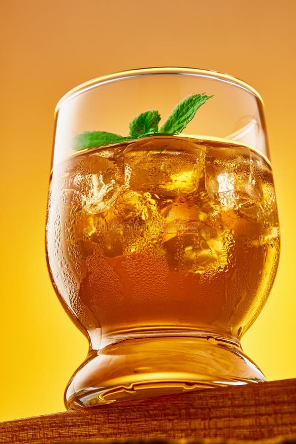 Close Up Glass of Refreshing Iced Tea with Ice Cubes and Mint Leaves ...