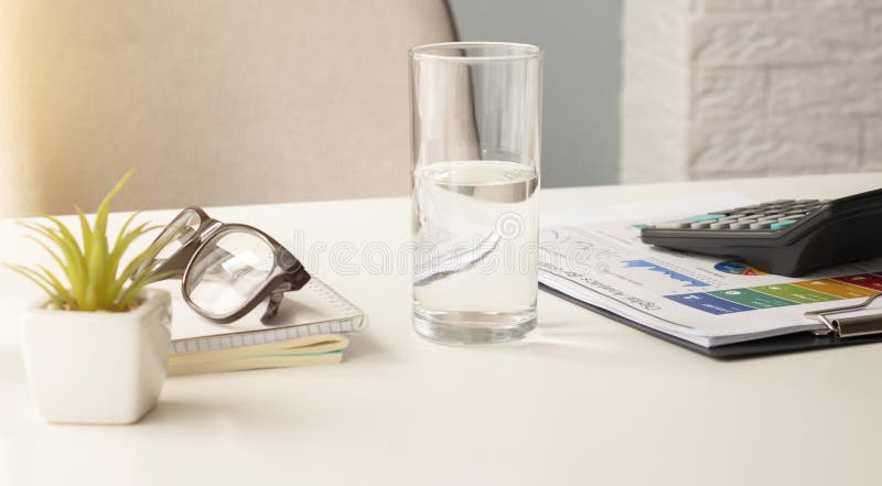 Close-up of Glass with Water on Desk with Stock Photo - Image of young ...