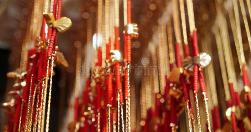 Close-up of Gold Chains Hanging in Row from Ceiling Inside Buddhist ...