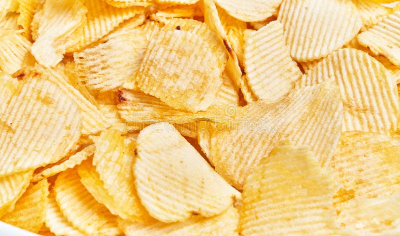 Close-up of Golden Crispy Potato Chips with Ridges, Filling the Frame ...