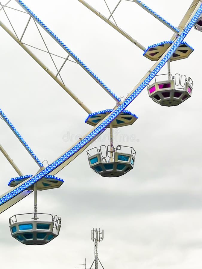 Close-up on 3 Gondolas of a Ferris Wheel with Blue Light Stock Image ...