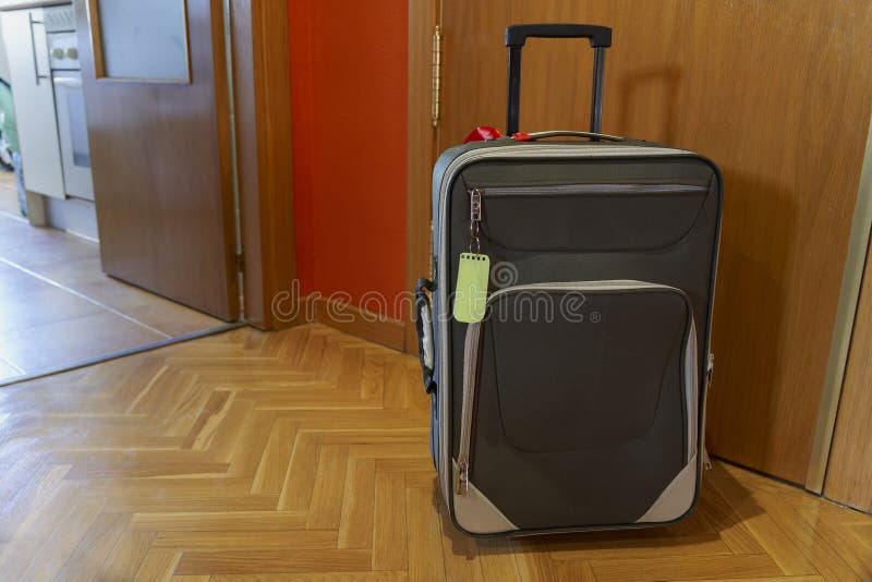 Close-up of a Green Suitcase at the Door of a House Stock Photo - Image ...