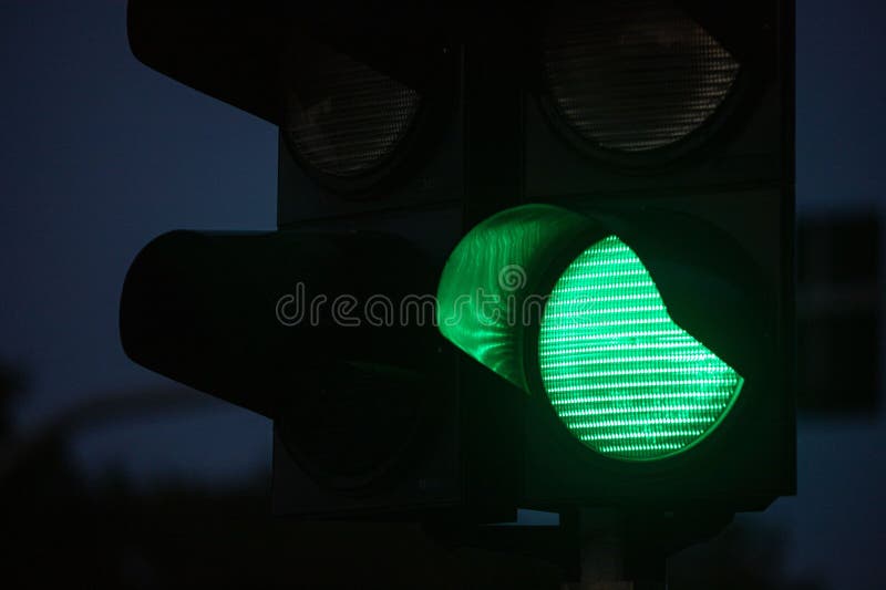 Close Up of a Green Traffic Signal Light Illuminated in the Dark Stock ...