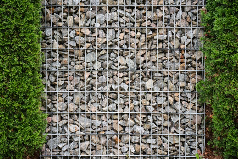 Close Up of Grid Fence with Stones and Green Trees Stock Image - Image ...