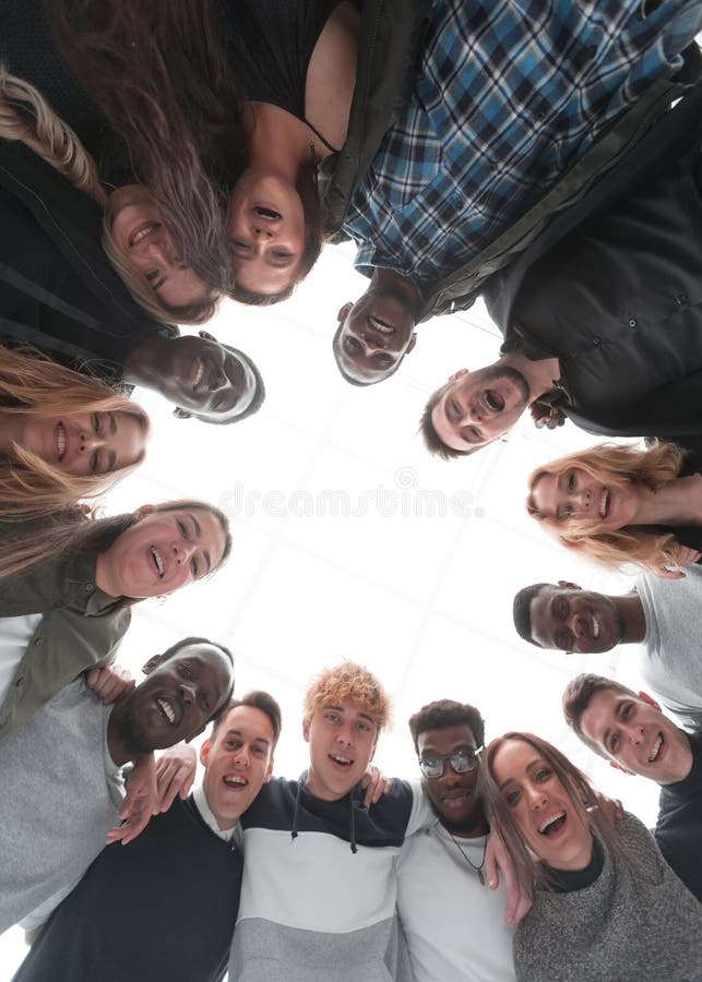 Close Up . Group of Cheerful Young People Standing in a Circle Stock ...