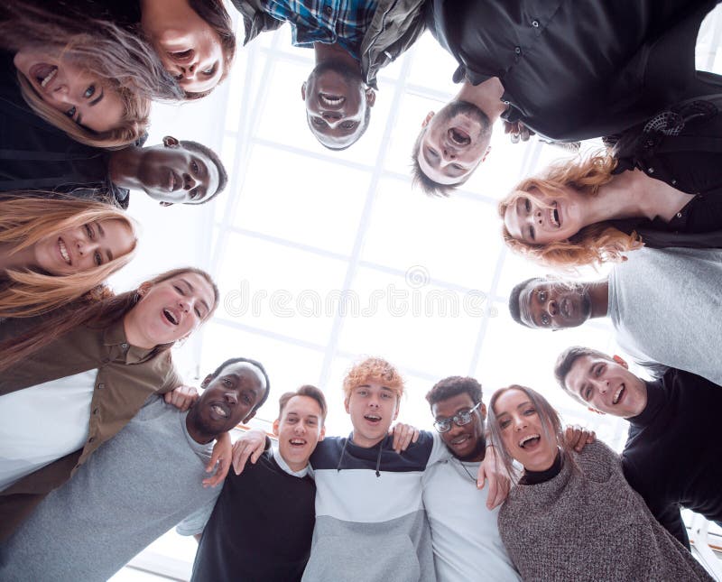 Close Up . Group of Cheerful Young People Standing in a Circle Stock ...