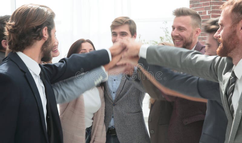 Close Up. a Group of Corporate Employees Showing Their Unity Stock ...