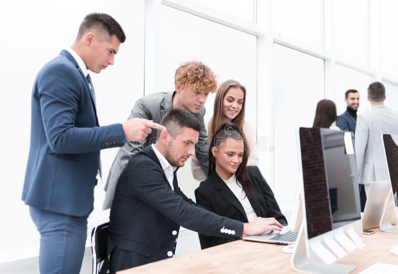 Group of Employees Reading Information on a Computer Screen Stock Photo ...