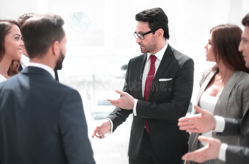 Close Up.a Group of Employees Talking Standing in a Circle Stock Image ...