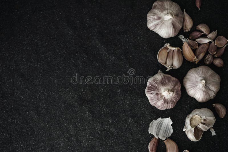 Close Up Group of the Garlic on Black Stone Texture with Copy Sp Stock ...