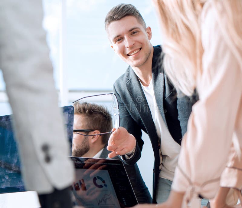 Close Up. Group of Office Employees Using a Laptop in the Office Stock ...