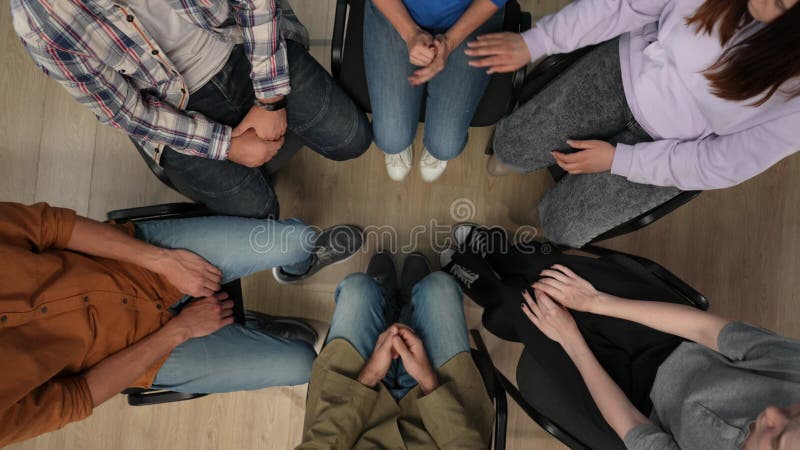 Close Up of a Group of People Sitting in a Circle in the Frame Above ...