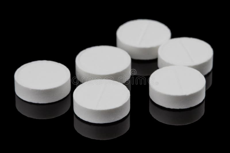 Close Up on a Group of Round Shape White Pill on the Dark Background ...